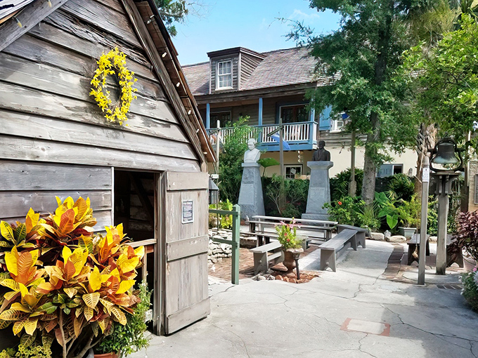 Weathered wooden walls tell stories of centuries past, while a cheerful yellow wreath welcomes modern-day visitors to this educational time capsule.