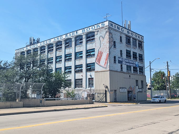 The weathered brick fortress of John K. King Books stands defiantly against Detroit's skyline, promising literary treasures within its industrial walls.