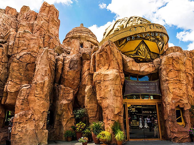 Ancient gods themselves might have carved this magnificent stone entrance, where theme park magic transforms into culinary reality.