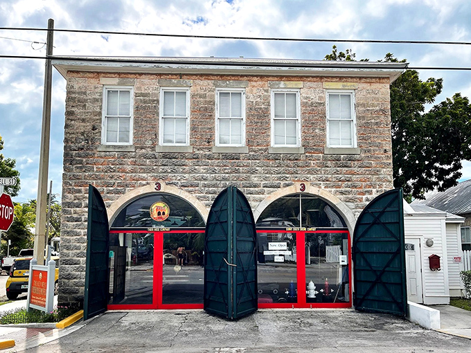 The historic stone facade with its distinctive red doors stands as a sentinel of safety, preserving Key West's firefighting legacy.