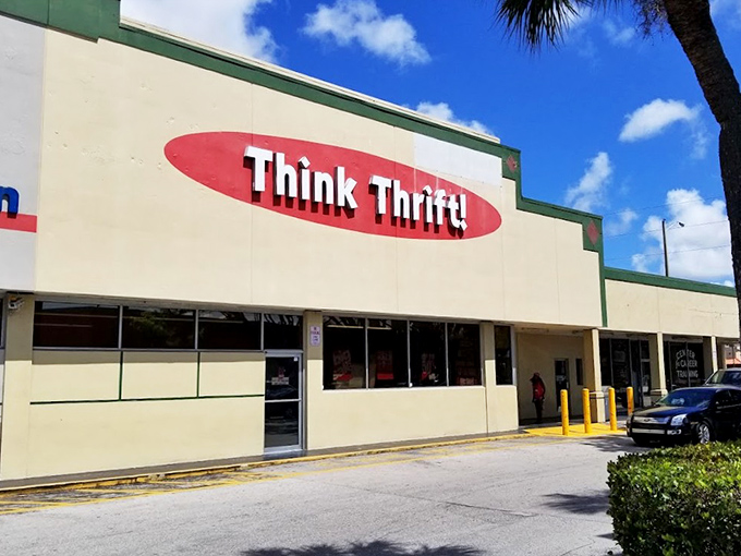 The iconic red oval "Think Thrift!" sign welcomes bargain hunters under Florida's blue skies, promising treasures within this unassuming retail wonderland.