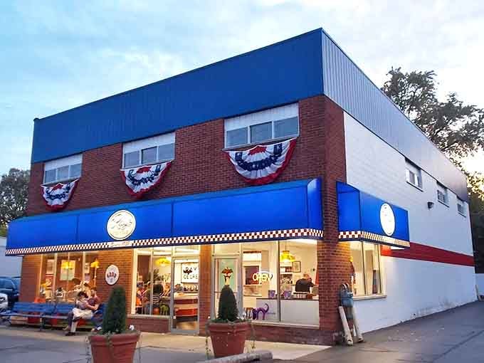 The iconic blue-trimmed exterior of Ray's Ice Cream stands as a beacon of sweetness in Royal Oak, complete with patriotic bunting that screams "American classic."
