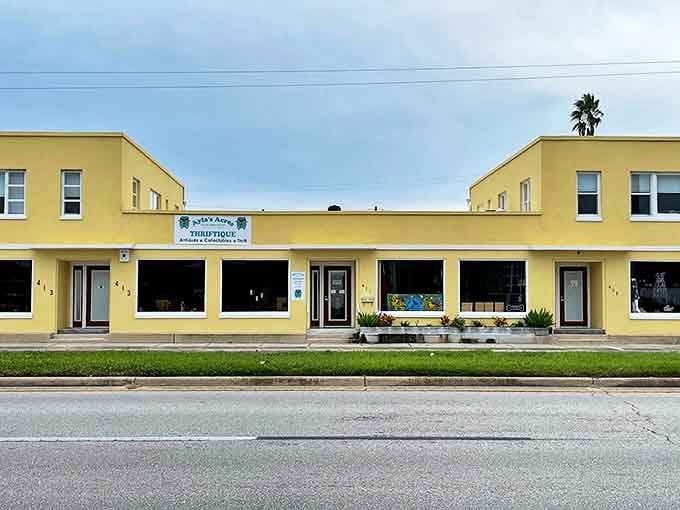 The cheerful yellow exterior of Ayla's Acres Thriftique beckons with promises of hidden treasures, standing bright against the Florida sky like a beacon for bargain hunters.