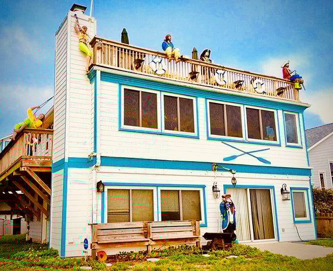 The Pirate House stands proudly against the Florida sky, its turquoise trim framing a crew of swashbucklers who've clearly found their land legs.
