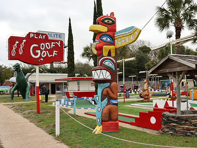 The iconic Goofy Golf sign stands proudly alongside a colorful totem pole, beckoning travelers with promises of whimsical putting adventures.