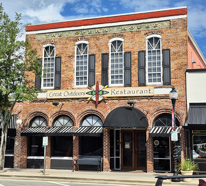 The historic Opera House building now houses Great Outdoors Restaurant, its brick façade and classic windows inviting passersby into a world of culinary comfort.