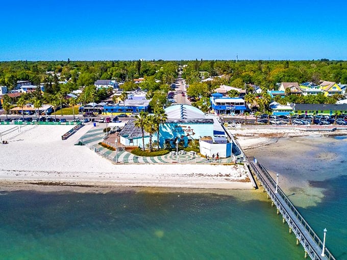 Aerial view of Gulfport's waterfront district, where sugar-white beaches meet colorful buildings and swaying palms – Florida's best-kept secret hiding in plain sight.