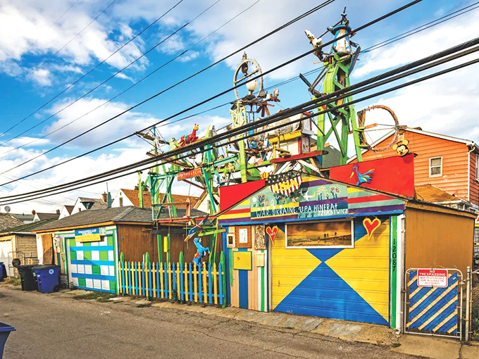 Hamtramck Disneyland erupts from the residential landscape like a fever dream, its rainbow facade and whirligigs defying suburban conformity.