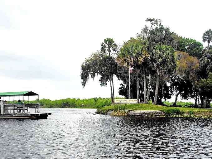 Hontoon Island State Park welcomes visitors with a serene waterfront vista where Spanish moss-draped trees frame the St. Johns River like nature's own welcoming committee.