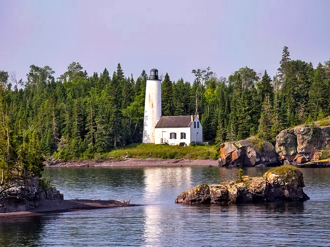 The iconic lighthouse stands sentinel against a backdrop of evergreens – Isle Royale's version of a welcome committee with better posture.