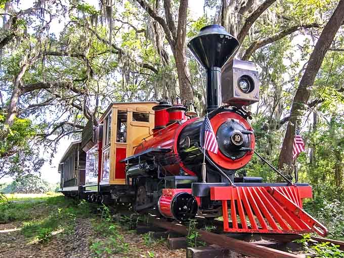 A gleaming red locomotive stands ready for adventure, its vintage charm promising a journey back to simpler times at Kirby Family Farm.