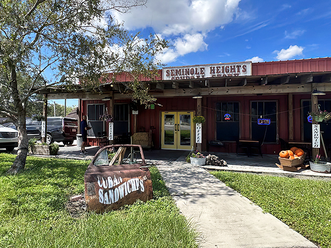 The rustic charm of Seminole Heights General Store welcomes hungry visitors with its weathered wood, bright yellow door, and promise of Cuban sandwiches.