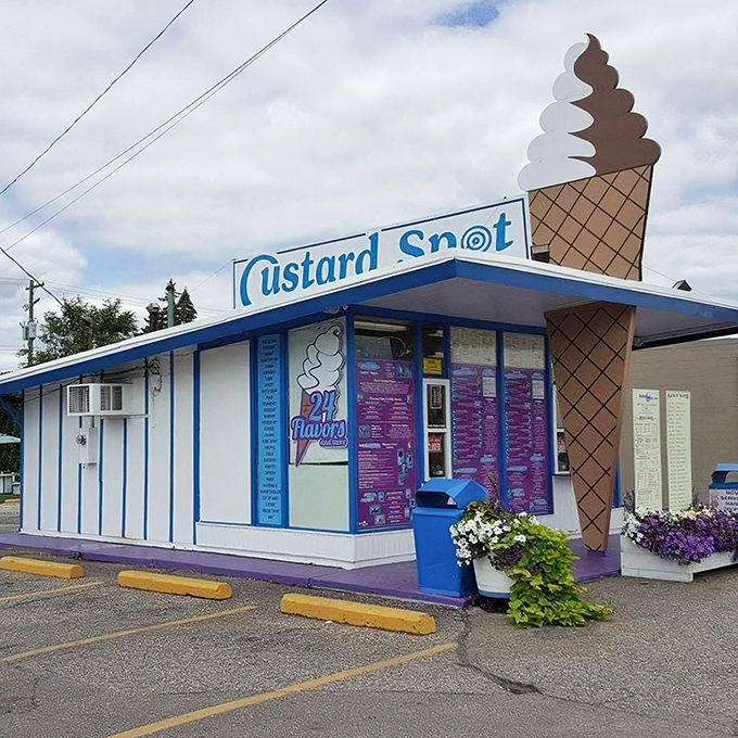 The iconic blue-and-white Custard Spot building stands proudly with its giant ice cream cone sign, a beacon of sweet promises in Utica.