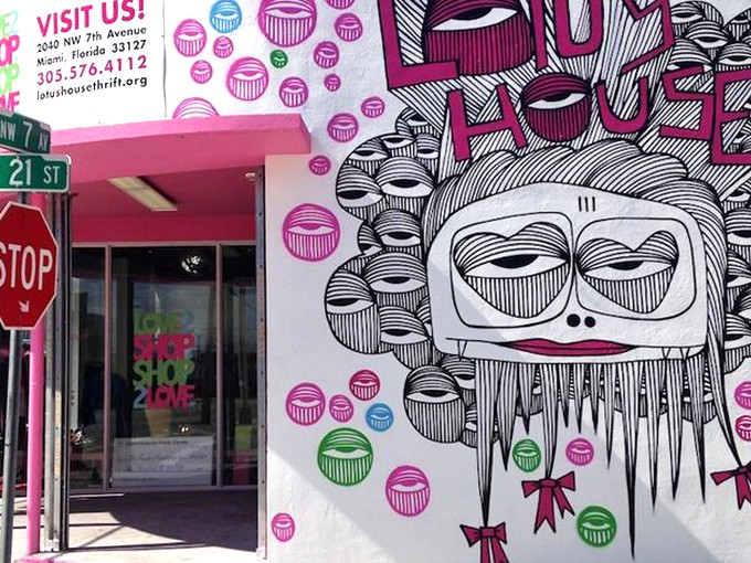 The vibrant pink exterior of Lotus House Thrift Chic Boutique features whimsical street art that stops Miami pedestrians in their tracks &ndash; fashion with personality before you even step inside.
