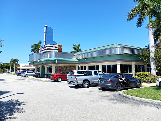 Mel's Diner's mint-green exterior stands like a retro time capsule under Florida's blue sky, promising comfort food that transcends decades.