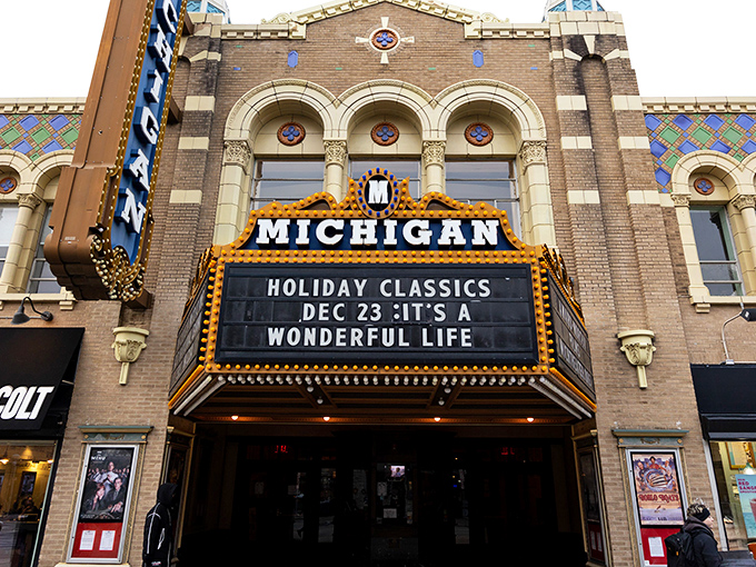 The Michigan Theater's marquee blazes with golden light, promising not just a movie but a journey back to Hollywood's golden age.