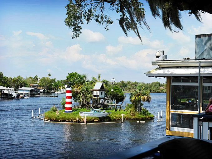 Monkey Island emerges from the Homosassa River like a primate paradise mirage – complete with lighthouse, tiny house, and zero property taxes.
