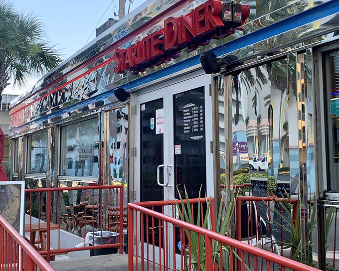 The gleaming chrome exterior of 11th Street Diner shines like a beacon of nostalgia on Miami Beach, promising classic American comfort with a side of style.