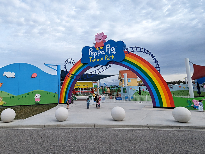 The iconic rainbow entrance to Peppa Pig Theme Park welcomes visitors with vibrant colors and childlike wonder – just like stepping into your TV screen on a sunny Florida day.