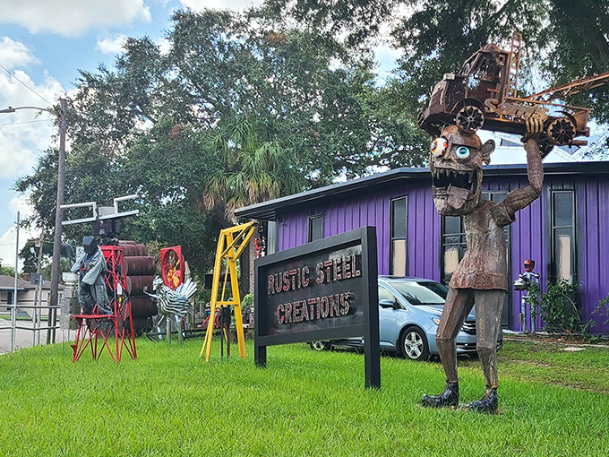 The vibrant purple headquarters of Rustic Steel Creations stands out like an artistic rebellion against Florida's beige landscape, metal guardians keeping watch.