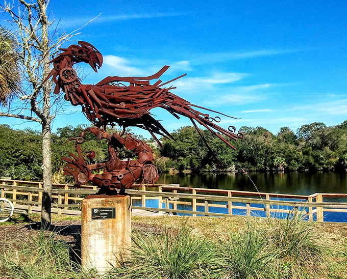 A rusty raptor takes flight without leaving its perch &ndash; this metal masterpiece watches over Lake Anhinga with mechanical majesty.