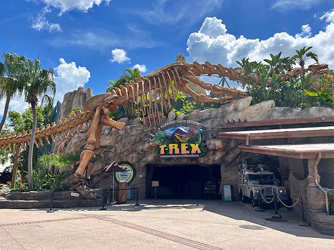 The jaw-dropping entrance to T-Rex Cafe, where a massive dinosaur skeleton welcomes hungry time-travelers to this prehistoric paradise.