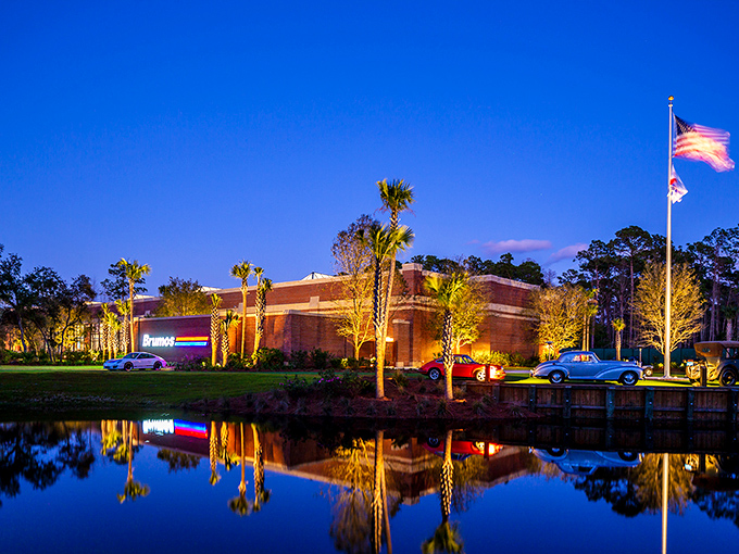 The Brumos Collection gleams at twilight like a jewel box for automotive royalty, its reflection doubling the beauty in classic Florida style.