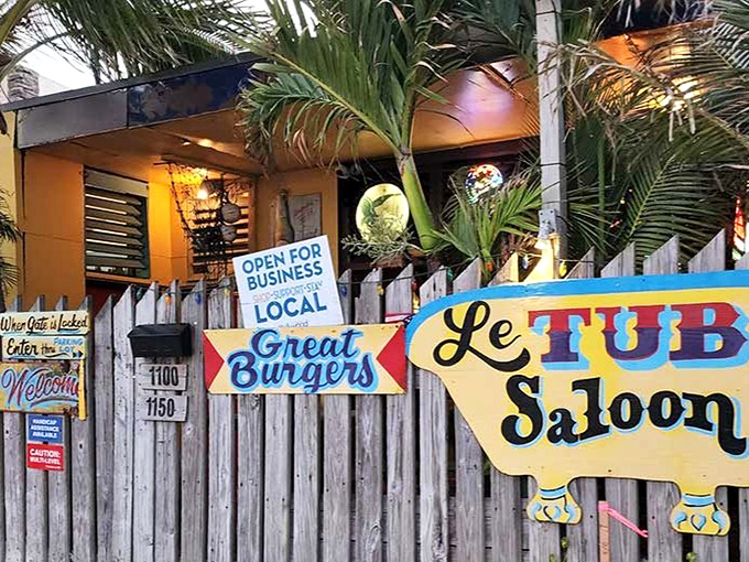 Le Tub's weathered wooden fence and colorful signage promise "Great Burgers" behind an entrance that looks more like a secret hideaway than a world-famous eatery.