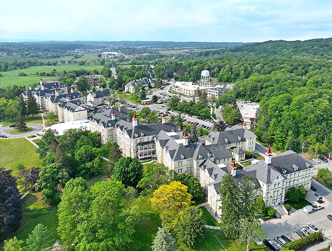 Victorian-Italianate grandeur stretches across the horizon, cream-colored buildings crowned with red turrets – a former asylum transformed into Michigan's most distinctive shopping destination.