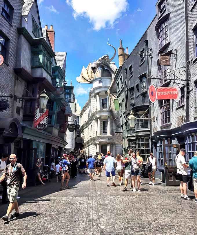Diagon Alley unfolds like a dream, with crooked buildings leaning impossibly toward each other and that fire-breathing dragon keeping watch over it all.