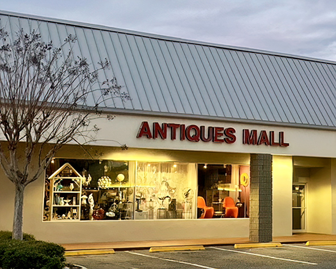 The unassuming exterior of Orange Tree Antique Mall hides a universe of treasures waiting to be discovered inside.