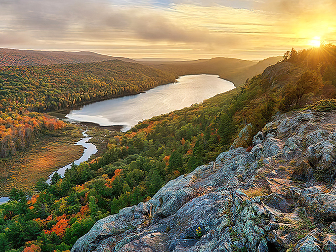 Sunset paints Lake of the Clouds in golden hues, transforming Michigan's hidden gem into a masterpiece that would make Bob Ross reach for his palette.