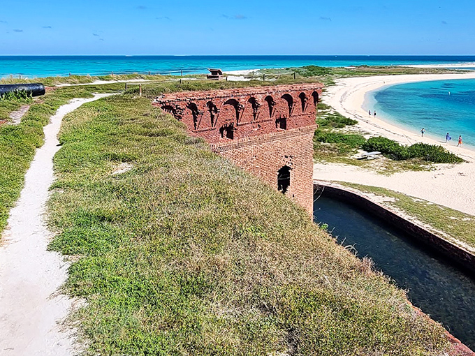 Fort Jefferson's imposing brick walls rise from turquoise waters, a 19th-century military marvel marooned in paradise.