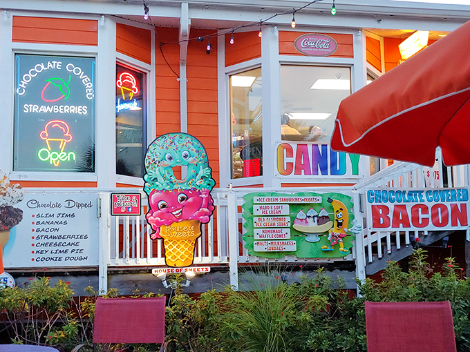 The vibrant orange facade of Meyer's House of Sweets beckons like a sugar-coated lighthouse amid Madeira Beach's coastal charm.
