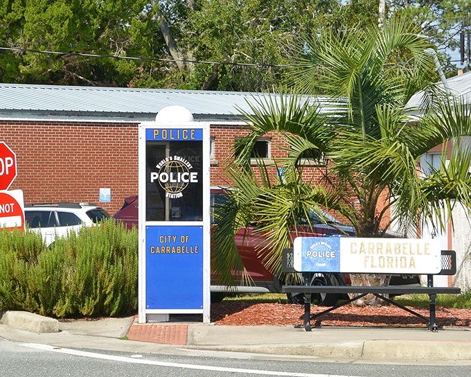 The brick building backdrop contrasts with the bright blue and white phone booth, Carrabelle's claim to fame as law enforcement goes pocket-sized.