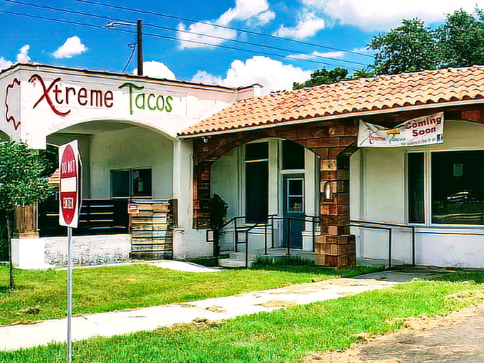 A humble stucco building with terracotta roof and "Xtreme Tacos" sign beckons adventurous eaters to discover what locals already know is culinary gold.