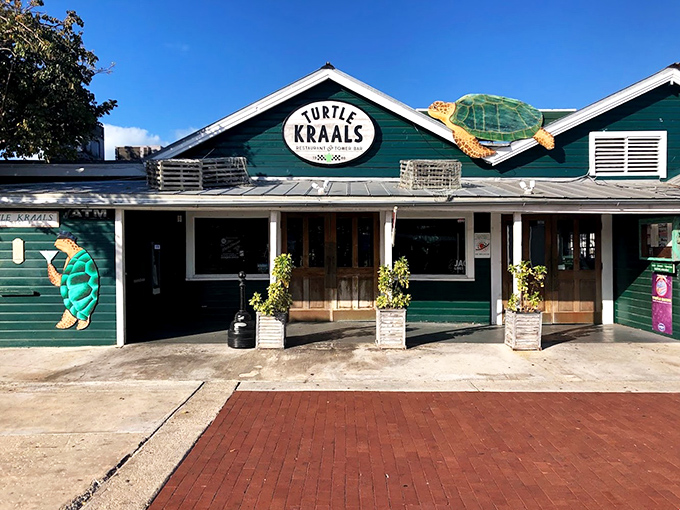 The iconic green facade of Turtle Kraals welcomes visitors with its whimsical turtle signage, promising seafood and quirky entertainment inside.