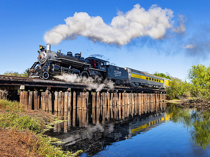 That magnificent beast of steam and steel crossing the trestle looks like it escaped from a Western movie, only with better weather and sweeter cargo.