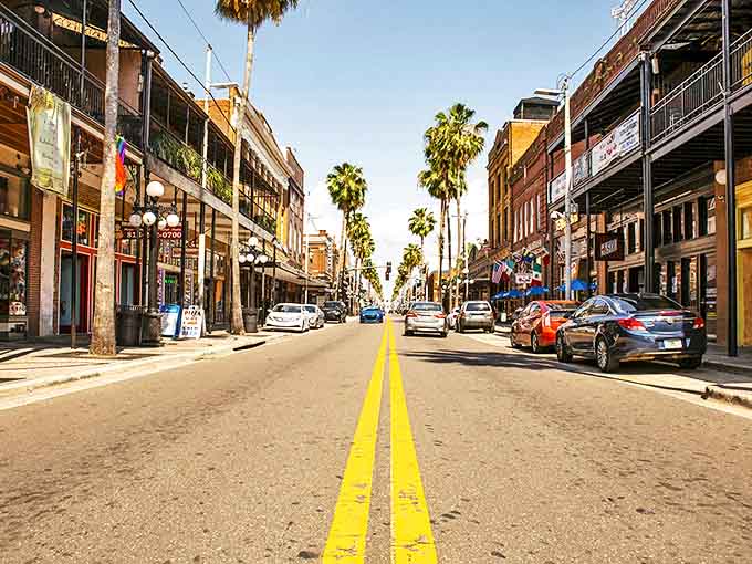 Ybor City: Palm trees line the historic brick-paved streets where Tampa's Cuban heritage thrives in a vibrant urban setting.