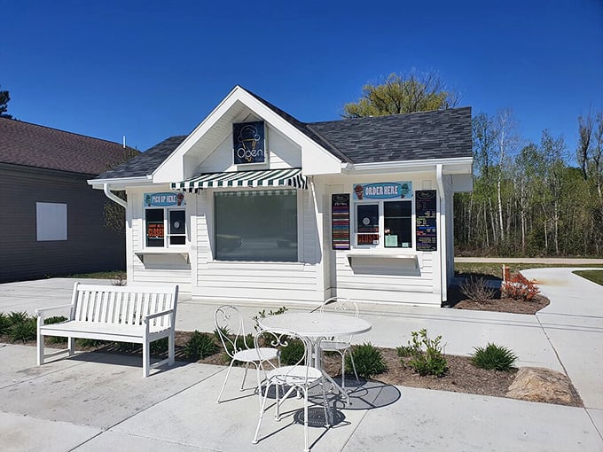 The charming white cottage exterior of Drost's beckons with striped awnings and the promise of sweet treasures within.
