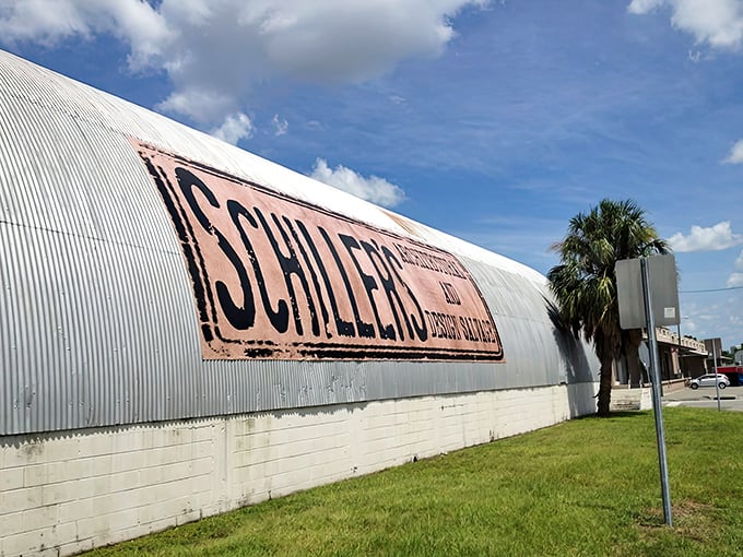 The curved metal exterior of Schiller's stands like a silver rainbow against the Florida sky, its weathered sign promising treasures within.
