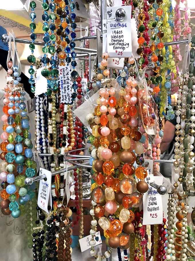 Vintage beads cascade in a waterfall of colors—each strand carrying whispers of cocktail parties, first dates, and glamorous nights out.