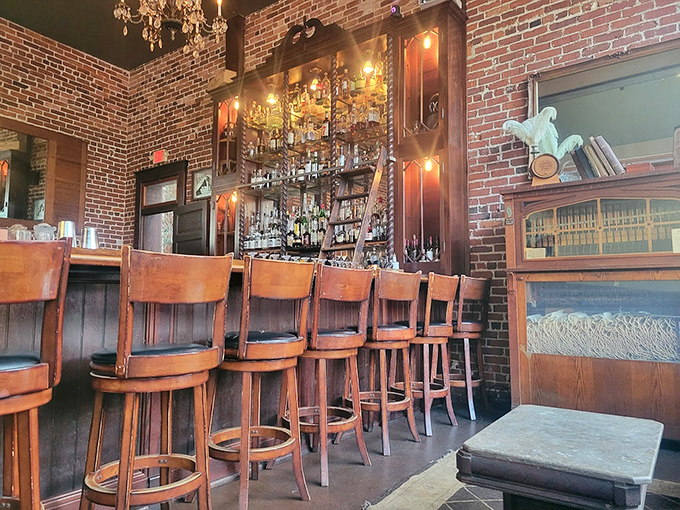 Wooden bar stools await patrons while the impressive spirits collection requires a library ladder &ndash; literature of the liquid variety.