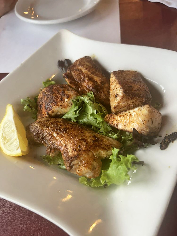 Blackened mahi bites that dance on the tongue &ndash; proof that sometimes the best seafood experiences come in small, perfectly seasoned packages.