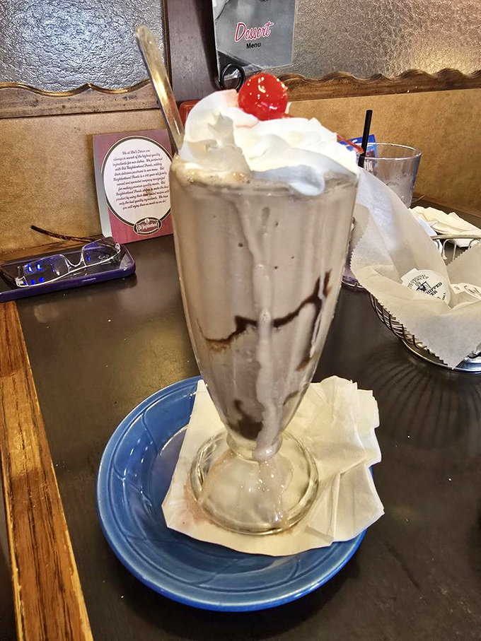 A milkshake so thick the straw stands straight up, crowned with whipped cream and a cherry &ndash; childhood nostalgia in a classic glass.