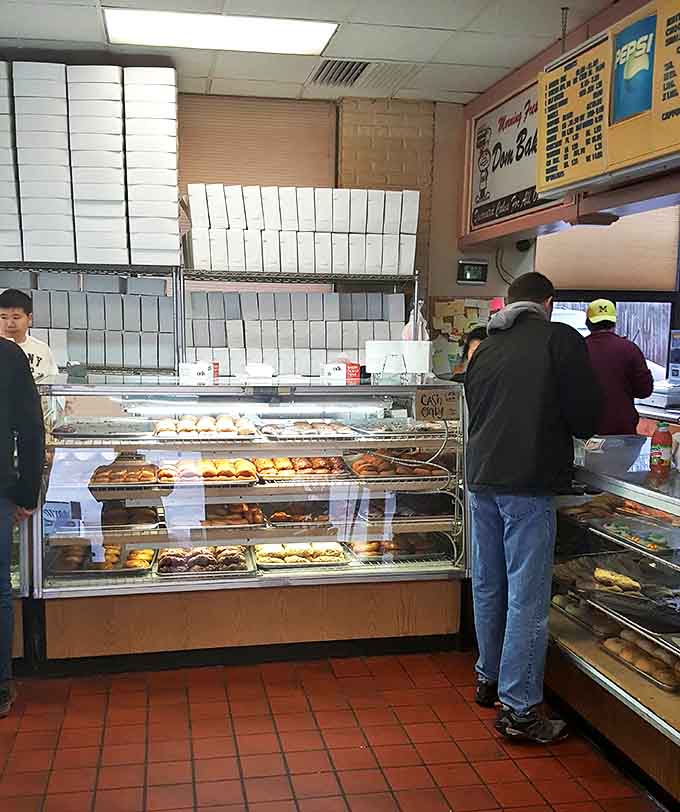The sacred exchange: customers making life-altering decisions at the counter while staff prepare to make dreams come true.