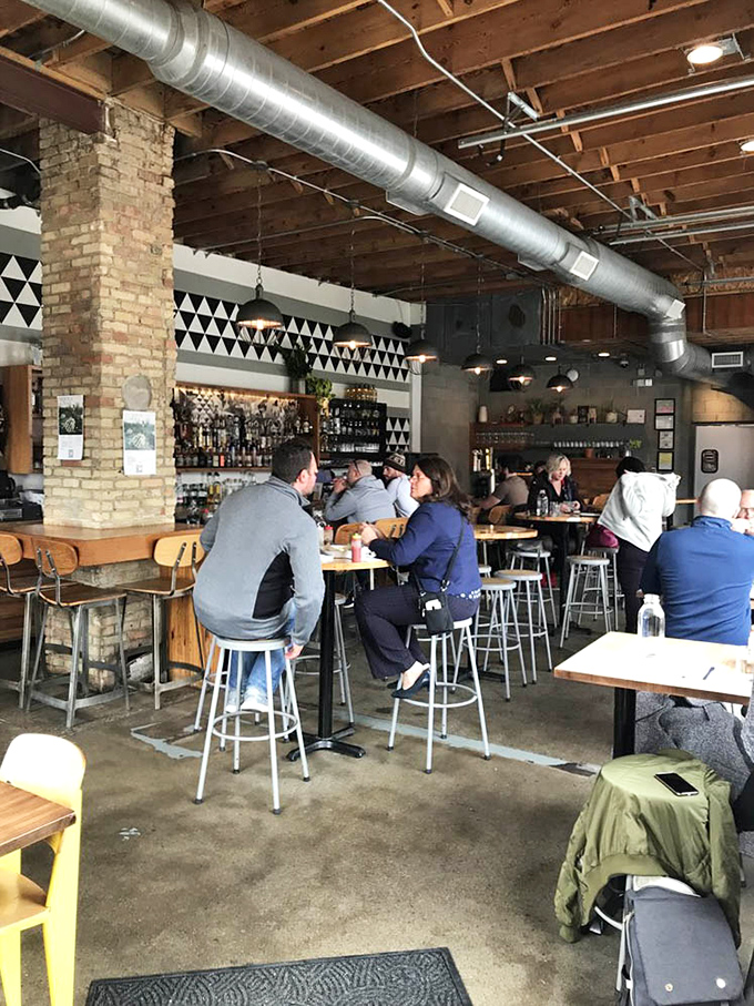 The dining area hums with conversation as patrons lean in over wooden tables, connected by good food and the shared joy of discovery.