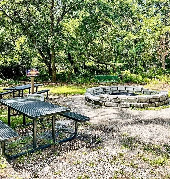 The stone fire circle and picnic area create a gathering space where stories are shared and memories made under Florida's generous sky.