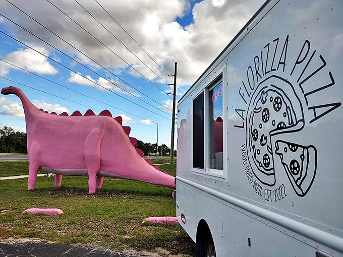 La Florizza Pizza food truck parks beside the dinosaur, creating a perfect pairing of vintage charm and modern eats.