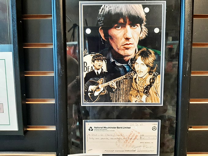 Groovy! A framed tribute to the "Quiet Beatle," George Harrison, featuring a photo collage and a fascinating piece of financial history.